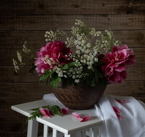 Premium Photo Still Life With Pink Peonies And Wild Flowers