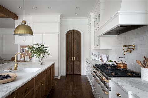 Kitchen With Huge Windows Over The Sink And White Marble Countertops In