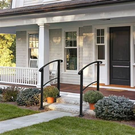 A House With White Siding And Black Front Steps