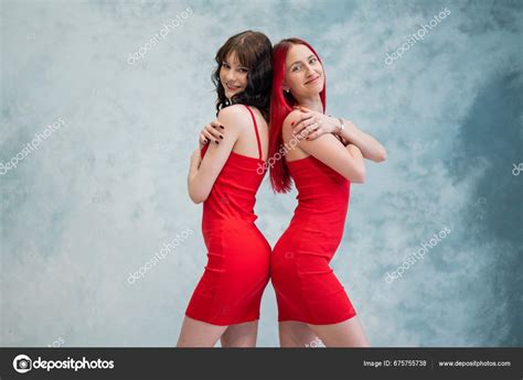 Portrait Two Women Dressed Identical Red Dresses Standing Back Back Stock Photo Inside