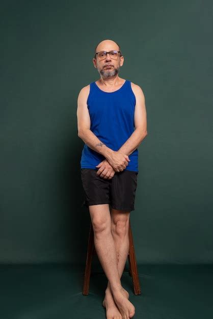 Premium Photo White Man In A Blue Shirt And Black Shorts Standing Posing For A Photo