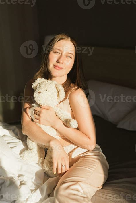 Portrait Of Girl Is Waking Up In Morning Stretches In Bed And Sun