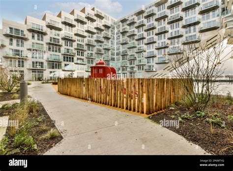 An Apartment Complex With A Fire Hydrant In The Middle And Trees On The