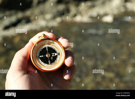 Man Using Compass For Navigation During Journey Outdoors Closeup Stock Photo Alamy