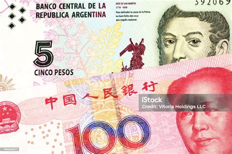 a peso note from argentina close up with a chinese yuan bill stock