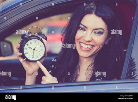 Happy Woman Driver Inside Her Car Showing Alarm Clock Stock Photo Alamy