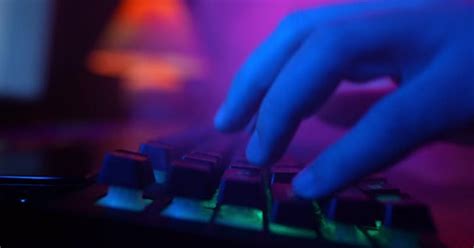 Male Hands Typing On Computer Keyboard In Neon Lighting Stock Video Envato Elements