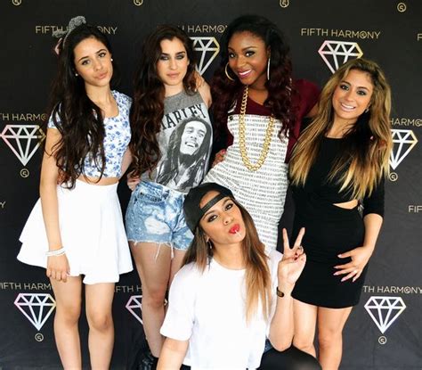 Four Beautiful Young Women Posing For A Photo In Front Of A Diamond