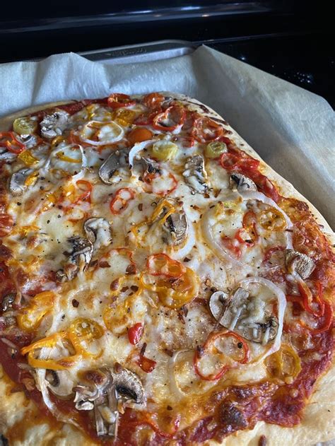 Delicious Homemade Pizza With Garlic Basil Dough And Spicy Red Sauce