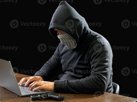Hacker Spy Man One Person In Black Hoodie Sitting On A Table Looking Computer Laptop Used Login