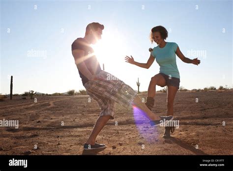 Couple Playing With Hackey Sack Outdoors Stock Photo Alamy