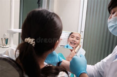 Male Dentist Explains Color Of Tooth Implant Whitening To A Female