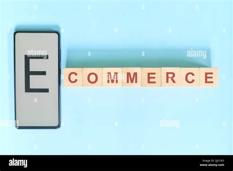 E Commerce Business Concept Hand Holding Mobile Phone With Word On