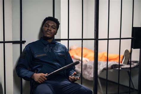 A Prison Warden Guards Cells With Prisoners Sentenced To Life In Orange