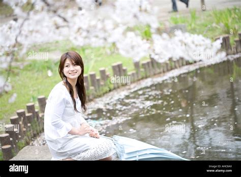Woman Under The Cherry Tree Stock Photo Alamy