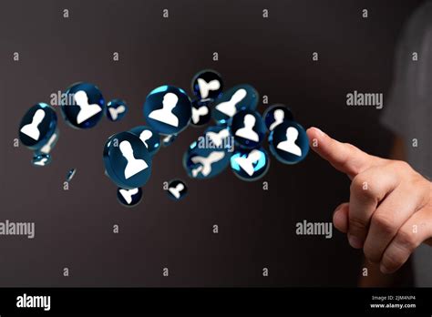A Closeup Of A Male Hand With Fingers Pointing At Illustrations Of User