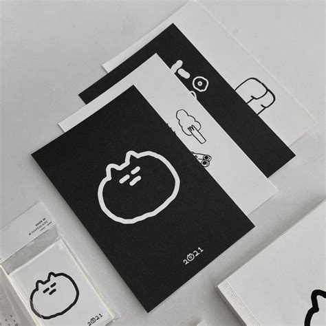 Some Black And White Papers On A Table With Stickers Scissors And