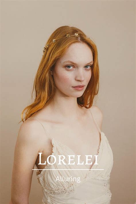A Woman With Red Hair Wearing A White Dress And Gold Headpiece