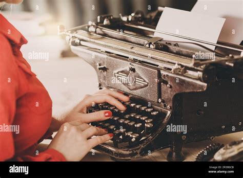 Secretary At Old Typewriter With Telephone Young Woman Using
