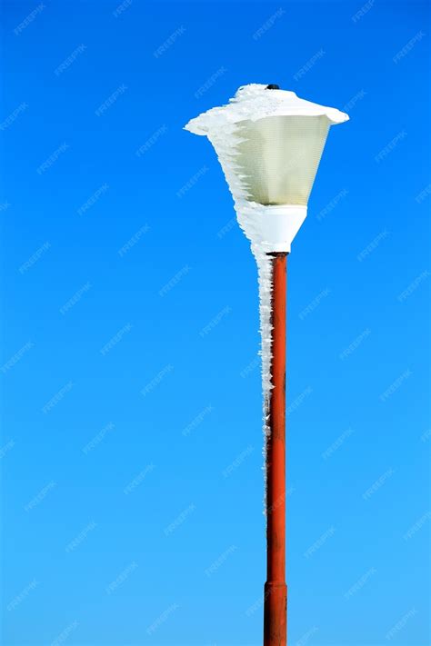 Premium Photo Frozen Street Light Against Clear Blue Sky