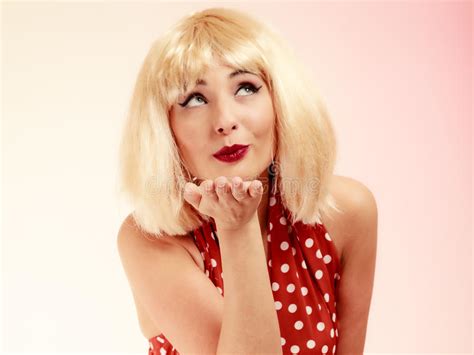 Pinup Girl In Blond Wig Retro Dress Blowing A Kiss Stock Image Image