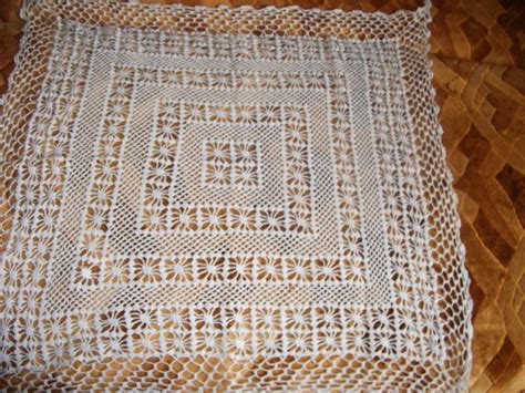 Crocheted White Blanket On Wooden Floor