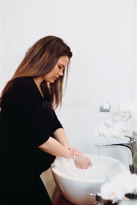 Woman Washing Hands At Home Using Disinfectant And Soap Tap Water And