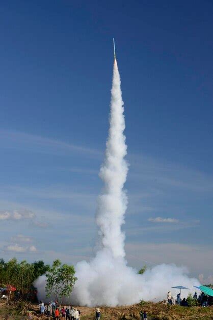 Premium Photo Rocket Taking Off From Field Against Sky