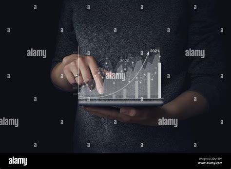 Virtual hologram of statistics, graph and chart with arrow up on hablet ...