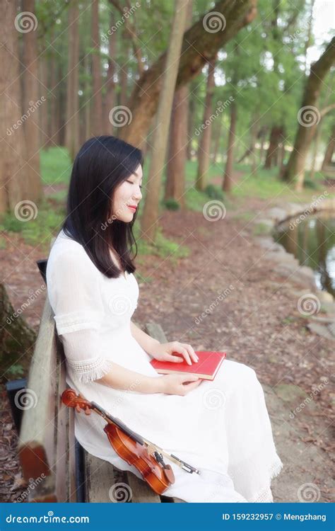 Portrait Of Aisan Chinese Girl Woman Student Read In Nature Outdoor