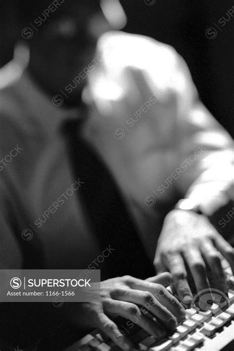 Mid Section View Of A Businessman Typing On A Computer Keyboard Superstock