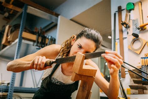 Young Woman Luthier Working In Handcrafted Spanish Guitar By Stocksy Contributor Victor