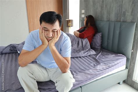 Sad Frustrated Middle Aged Asian Man Sit On Bed After Having Sex While