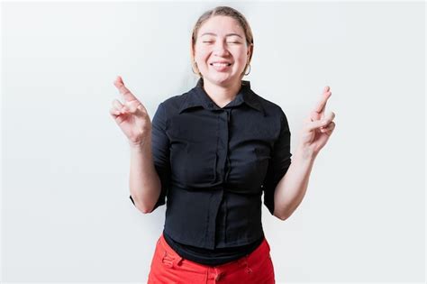 Premium Photo Smiling Hopeful Girl Making A Wish With Her Fingers