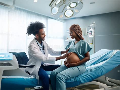 A Pregnant Woman In Scrubs Sits On An Examination Table Receiving