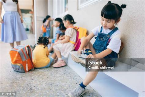 Students Put Their Shoes In The Shoe Cabinet Before Entering The