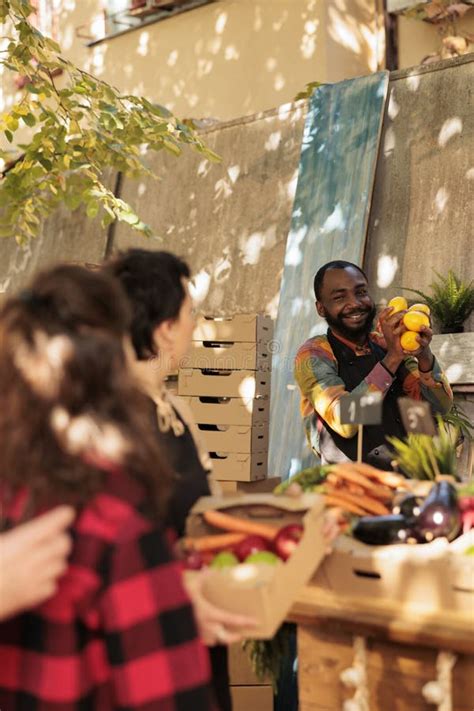 Happy African Guy Enjoying Working Day At Farmers Market Stock Image
