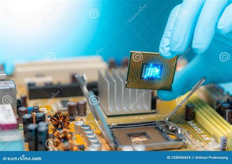Electronic Engineer Hand Putting Computer Chip On Socket Chipset On Electronic Circuit Board Of