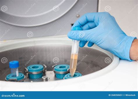 Closeup Of The Scientist Putting The Liquid Sample Into The Centrifuge