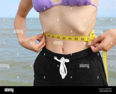 Skinny Young Girl With Eating Disorder Measuring Ther Waistline Stock