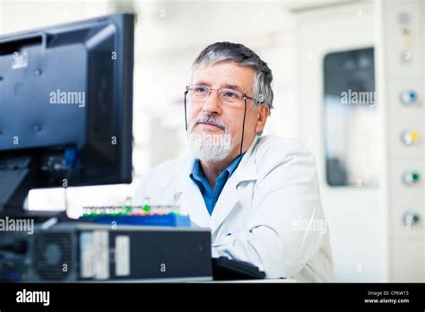 Senior Researcher Using A Computer In The Lab While Working On An