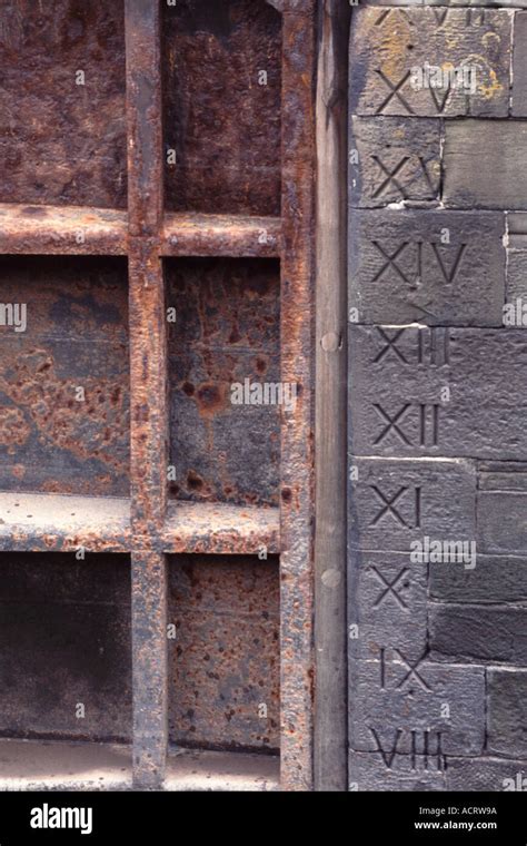 Rusty Metal Lock Gates With Roman Numerals Depth Markers Stock Photo