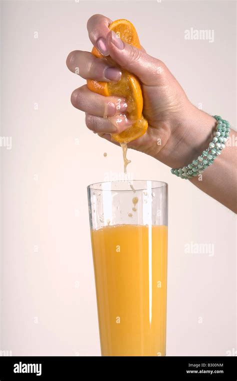 Woman Squeezing Orange, Making Orange Juice Stock Photo - Alamy