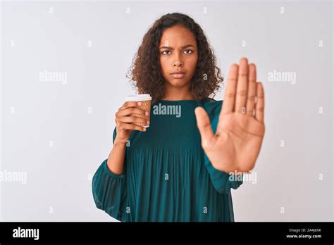 Young Brazilian Woman Drinking Take Away Coffee Standing Over Isolated