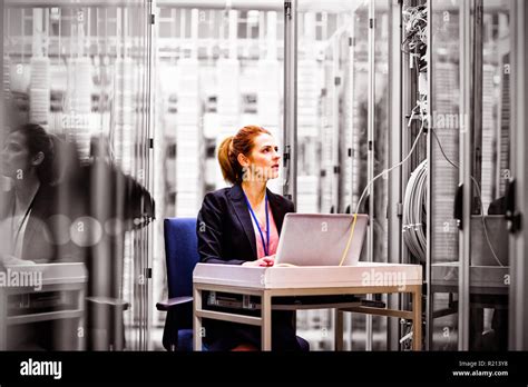 Technician Using Laptop While Analyzing Server Stock Photo Alamy