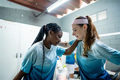 female soccer players doing warm up exercises in the locker room stock