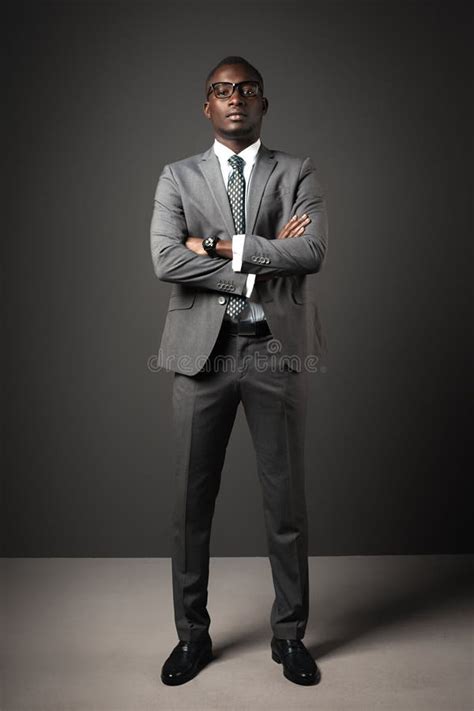 Serious Young Black Man With Glasses And Gray Business Suit Crossed His