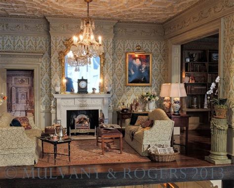 A Living Room Filled With Furniture And A Chandelier Hanging From The Ceiling Next To A Fire Place