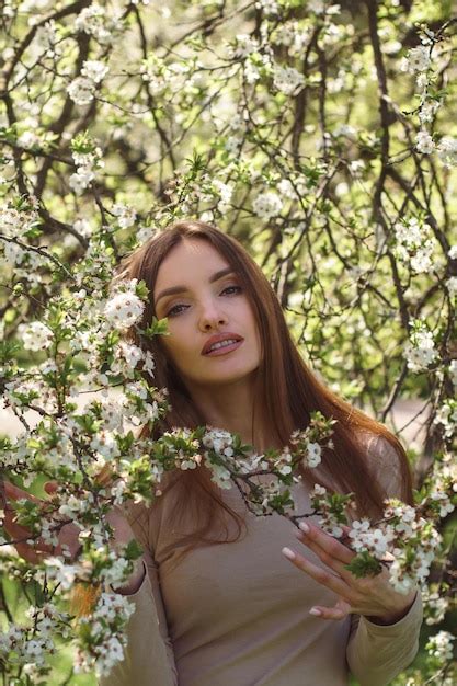 Premium Photo Beautiful Girl Posing In Cherry Blossom Garden