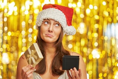 Premium Photo Woman Over Gold Background In Santa Claus Hat